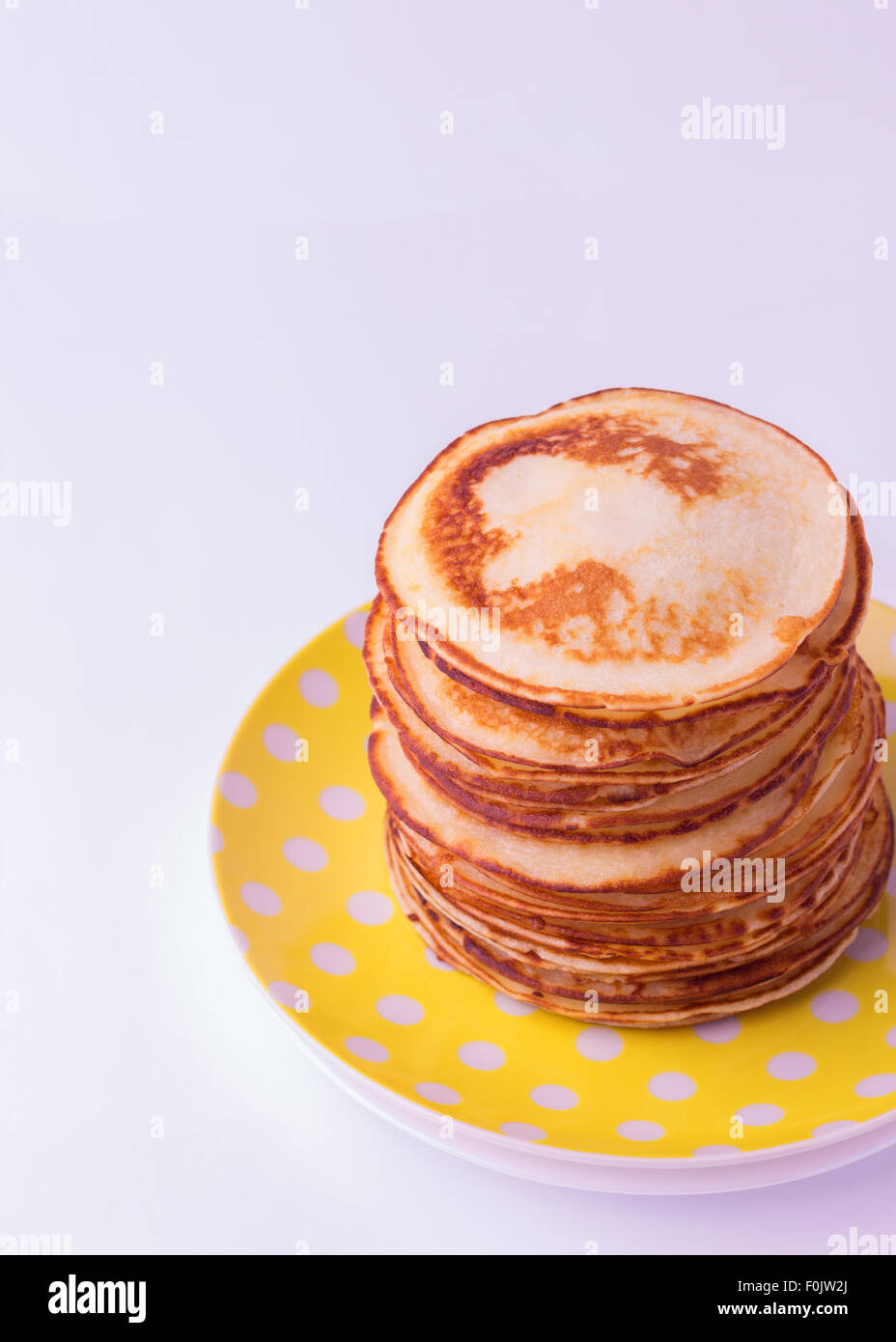 Stack of pancakes on a plate isolated on white background. Selective ...