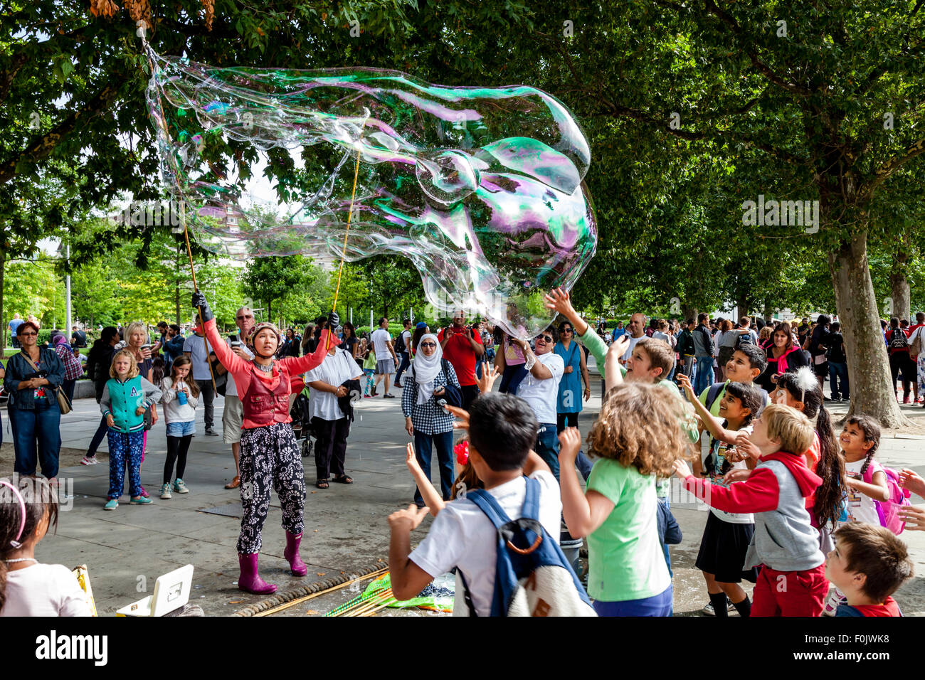 A Street Entertainer and Her Bubble Show, The Southbank, London ...