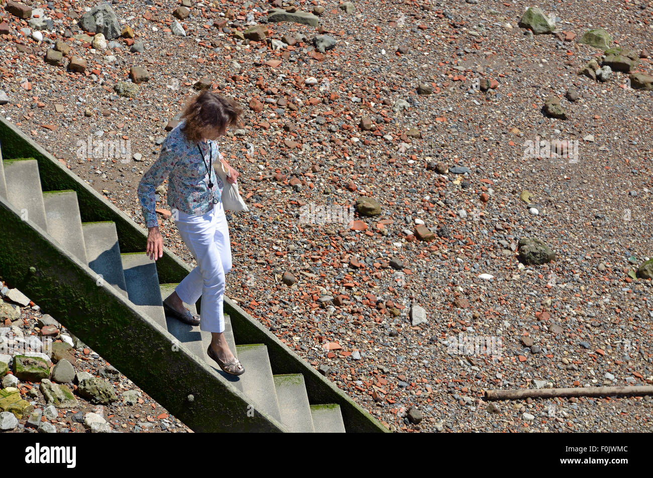 Woman descending old stone staircase hi-res stock photography and ...