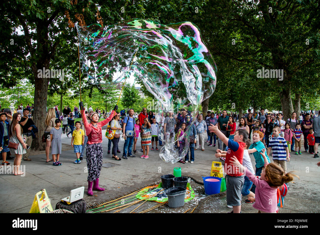A Street Entertainer and Her Bubble Show, The Southbank, London ...