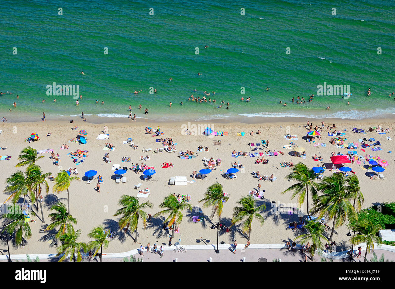 Overhead view of sunbathers lining the beach to soak up the sun and fun ...
