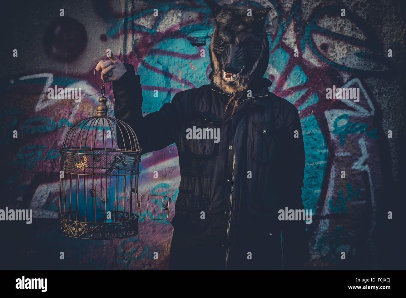 man dressed as werewolf cage and colored smoke Stock Photo - Alamy