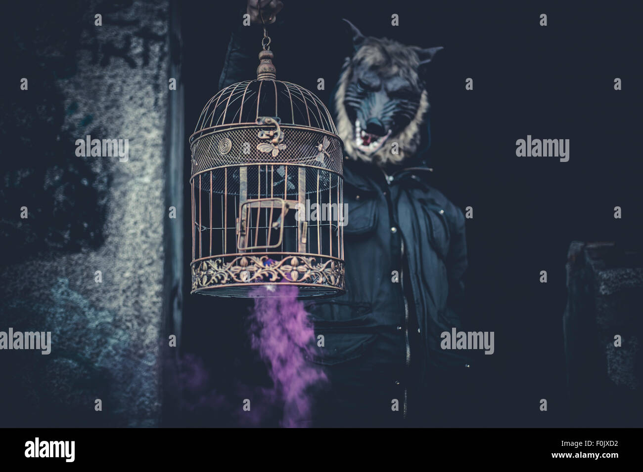 man dressed as werewolf cage and colored smoke Stock Photo - Alamy