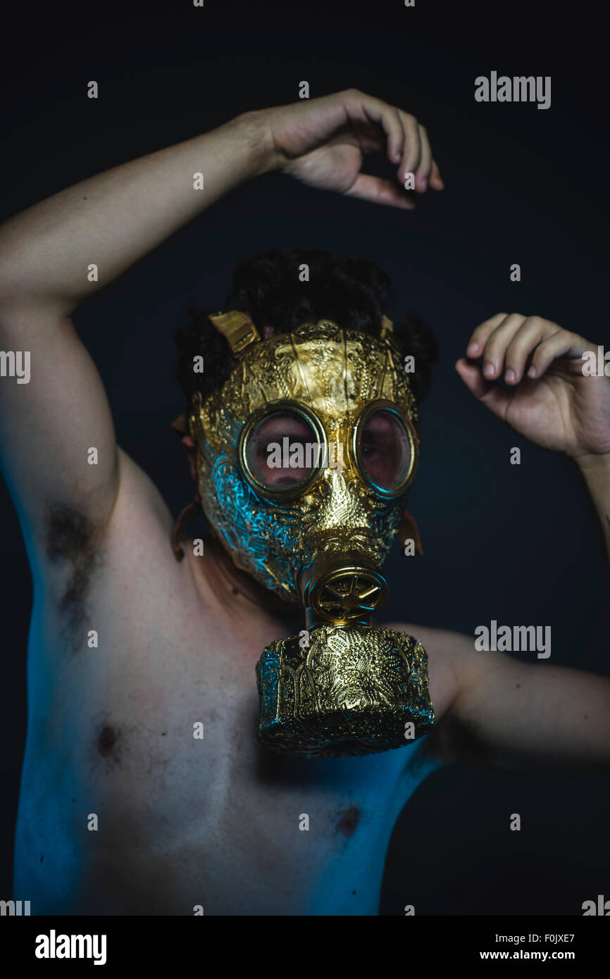 protection, depression and danger man with golden gas mask Stock Photo ...