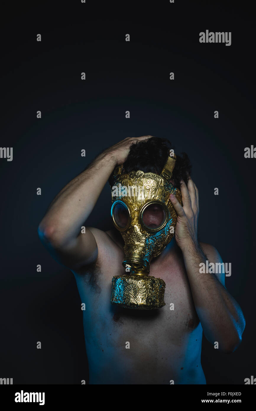 safety, depression and danger man with golden gas mask Stock Photo - Alamy