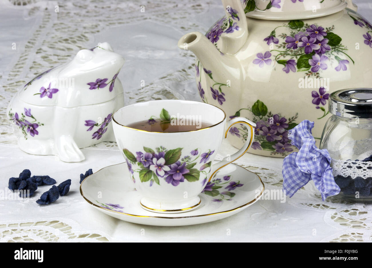 English afternoon tea with sweet and candied violets Stock Photo - Alamy