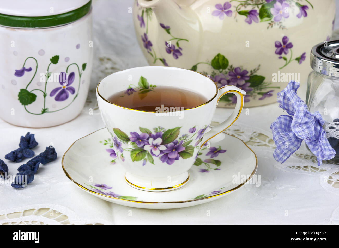 English afternoon tea with sweet and candied violets Stock Photo - Alamy