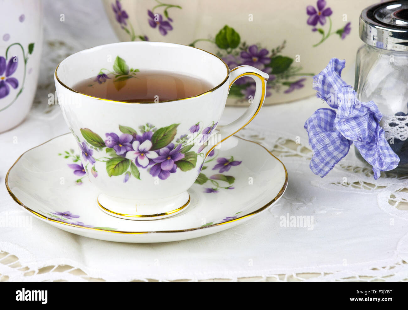 English afternoon tea with sweet and candied violets Stock Photo - Alamy