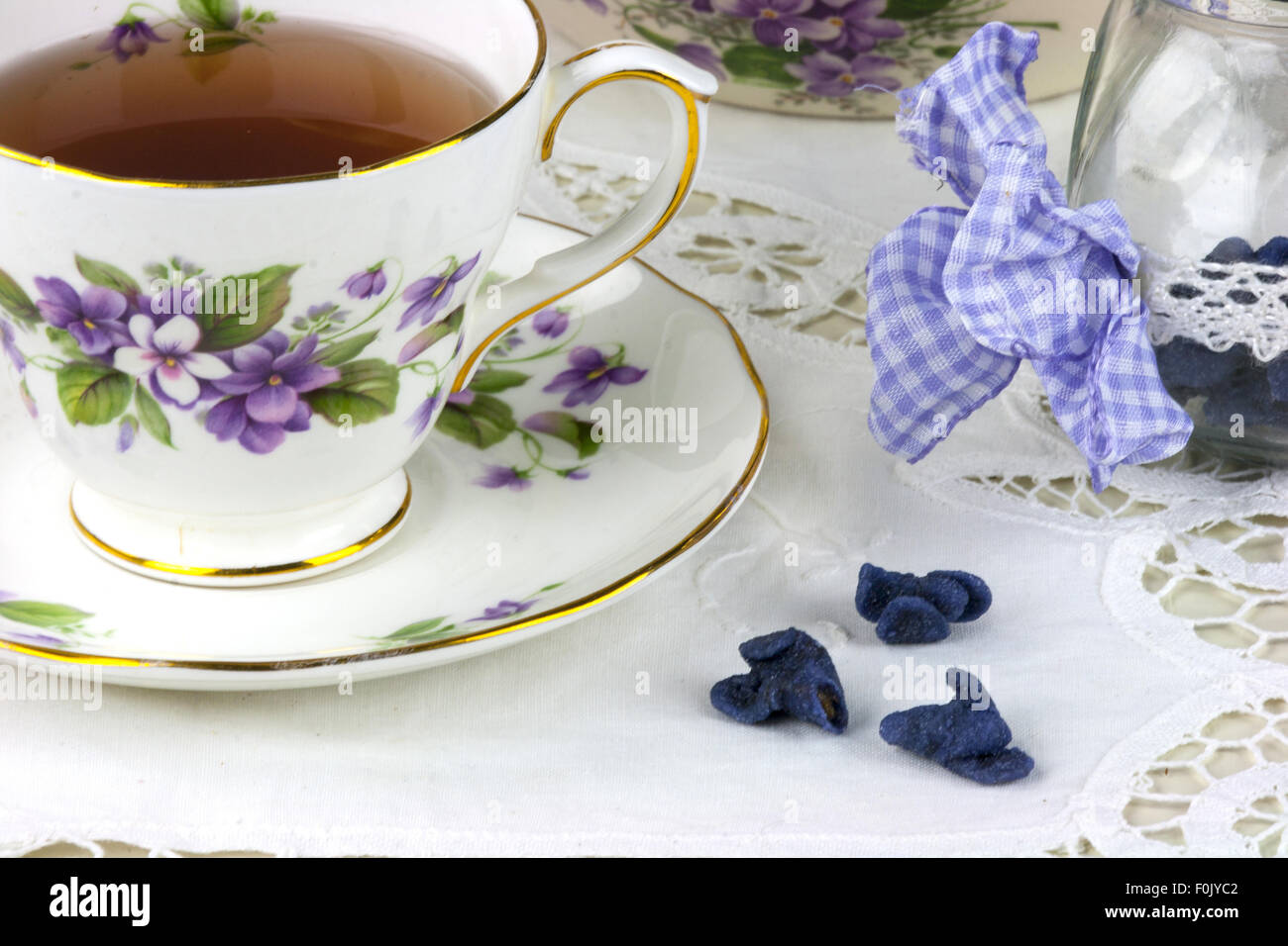 English afternoon tea with sweet and candied violets Stock Photo - Alamy
