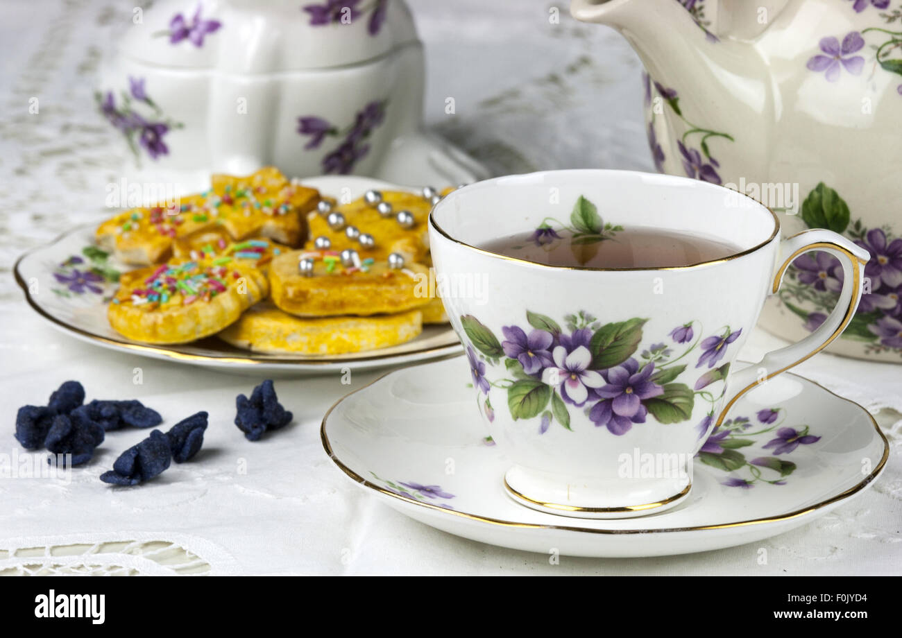 English afternoon tea with cookies and candied violets Stock Photo - Alamy