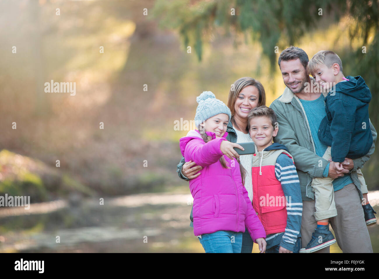 Family taking selfie with camera phone in woods Stock Photo - Alamy