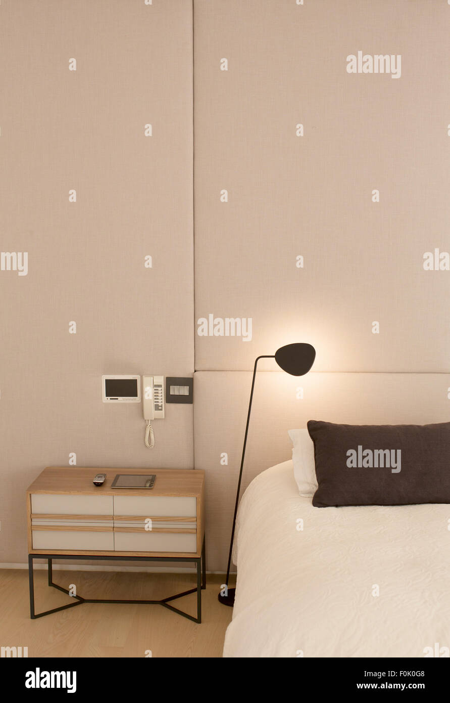 Illuminated lamp over bed Stock Photo - Alamy