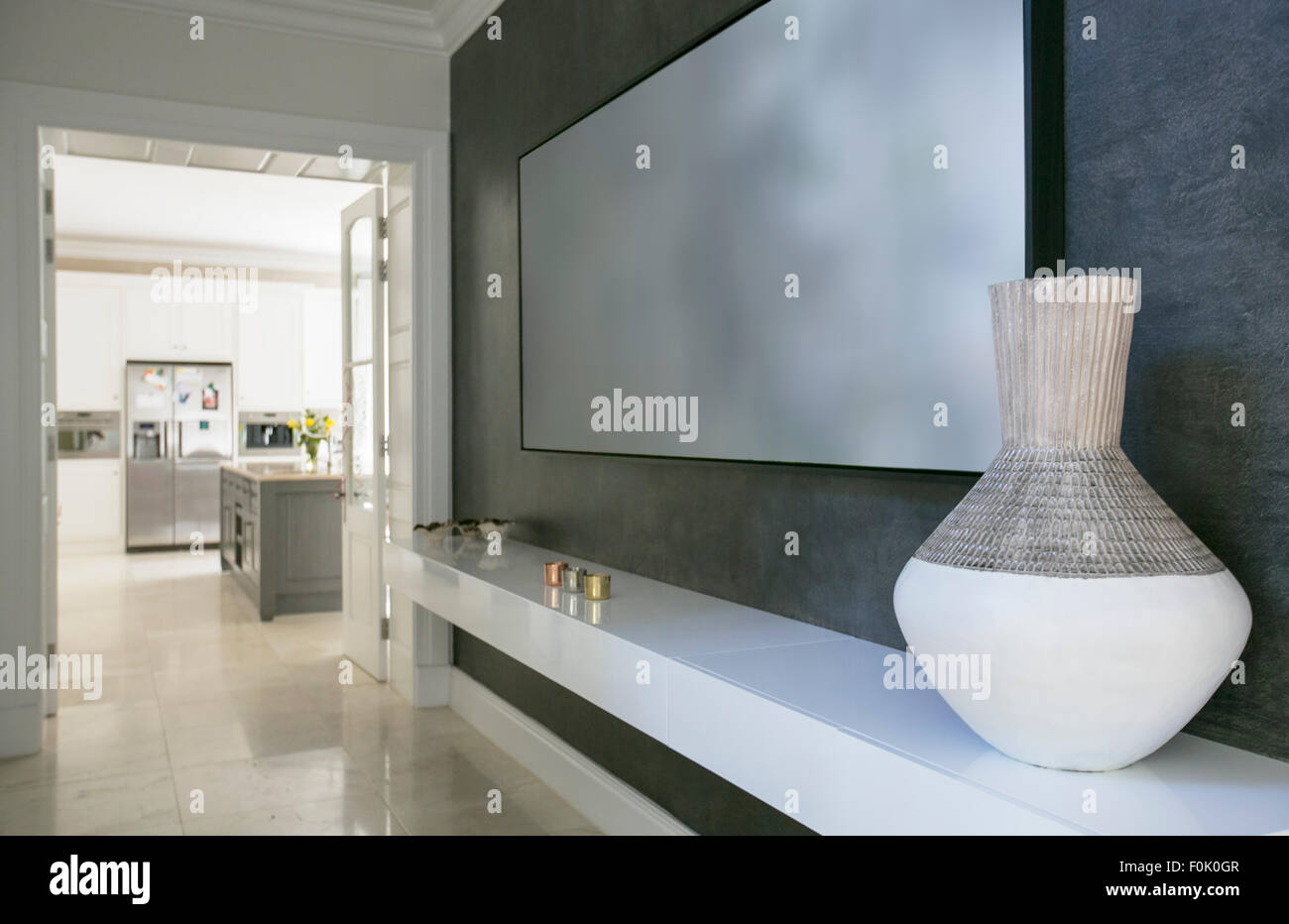 Home showcase foyer with large painting and vase Stock Photo - Alamy