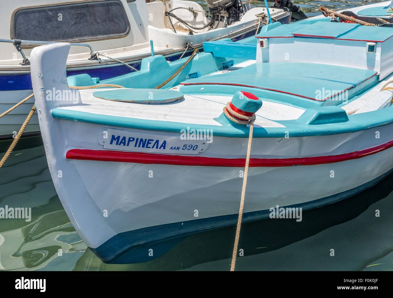 Small Greek fishing boat moored in harbour Stock Photo - Alamy