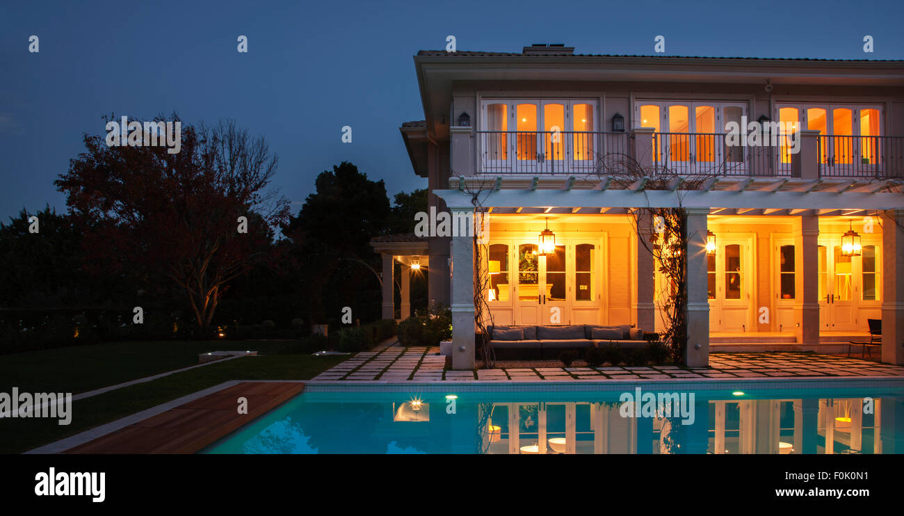 Illuminated luxury house with swimming pool at night Stock Photo - Alamy