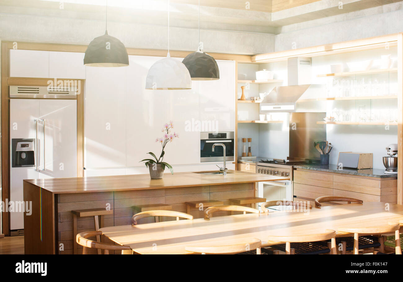 Modern kitchen and dining table Stock Photo - Alamy