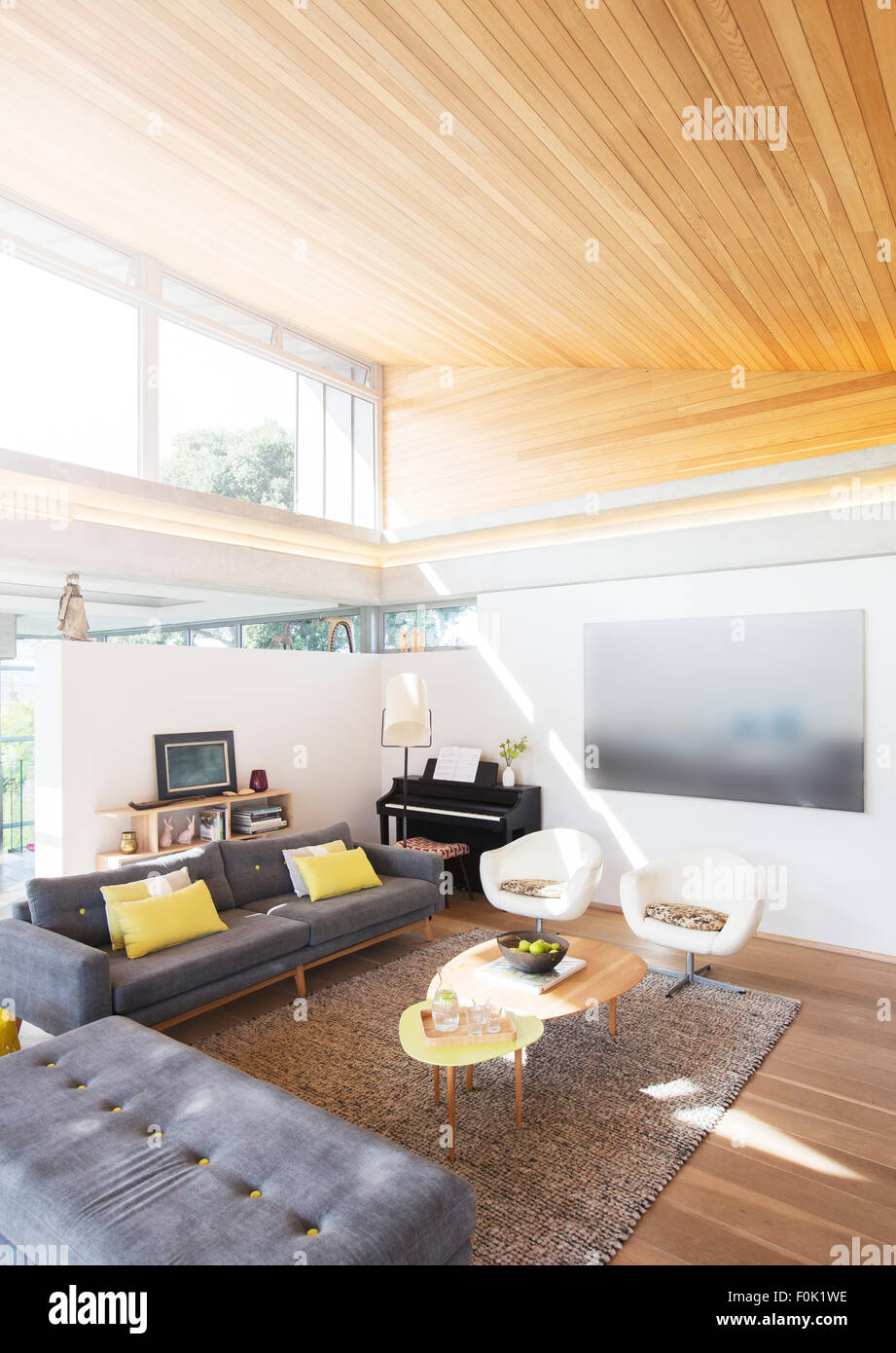 Slanted wood ceiling over living room Stock Photo - Alamy