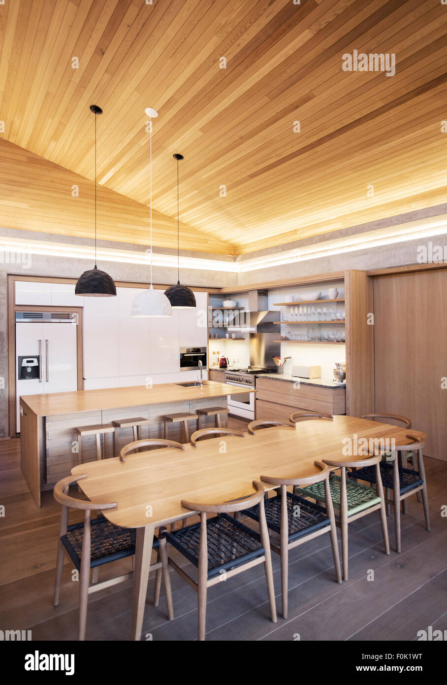 Illuminated slanted wood ceiling over kitchen Stock Photo - Alamy