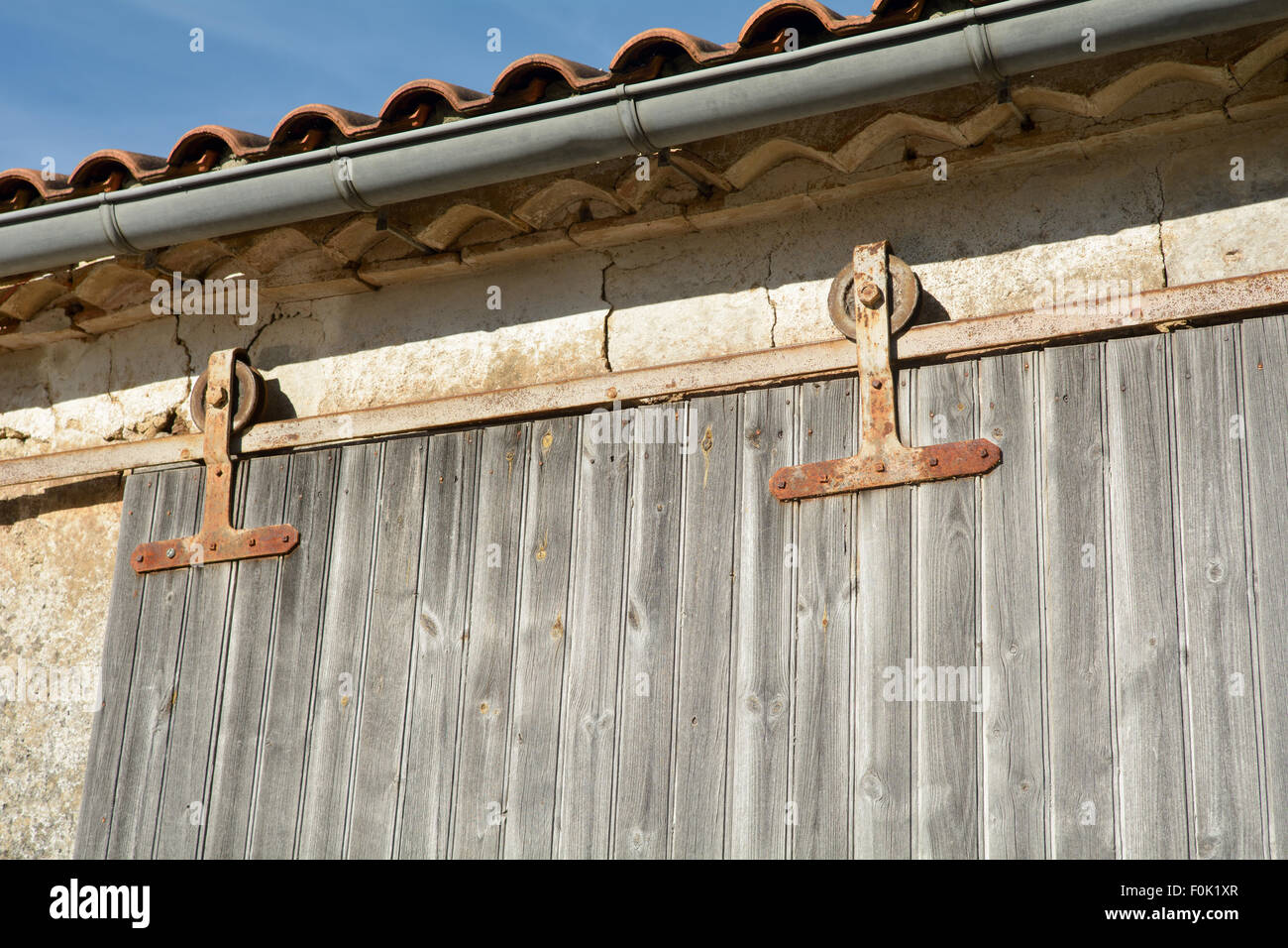 Sliding door wheel mechanism for barn in French countryside Stock Photo ...