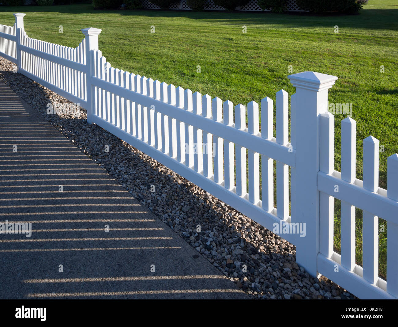 White picket fence that delineates the grass from the pathway Stock ...