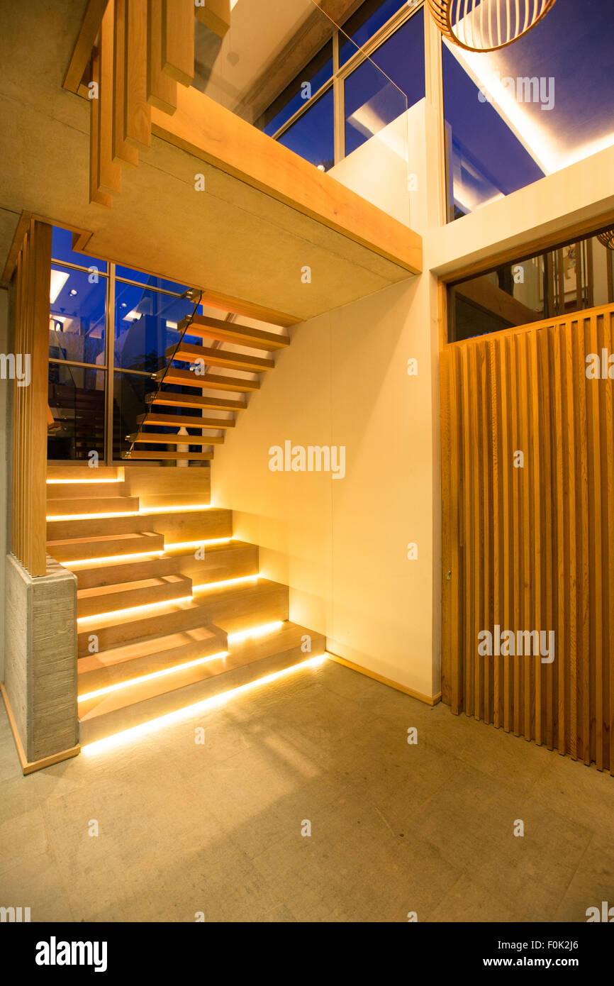 Illuminated modern stairs off foyer in luxury house Stock Photo - Alamy
