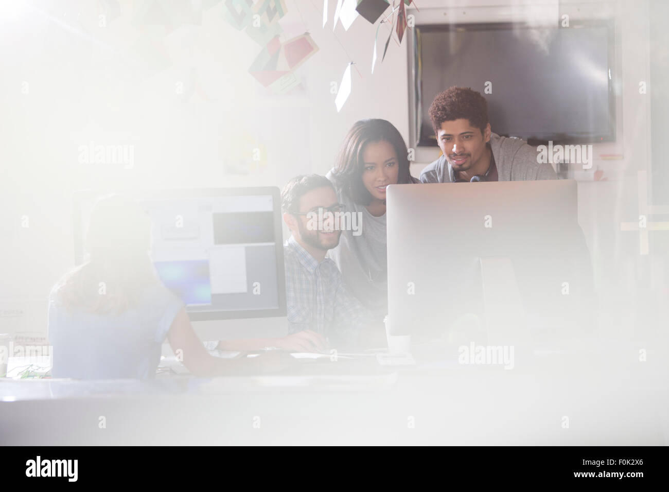 Creative business people using computer in office Stock Photo - Alamy