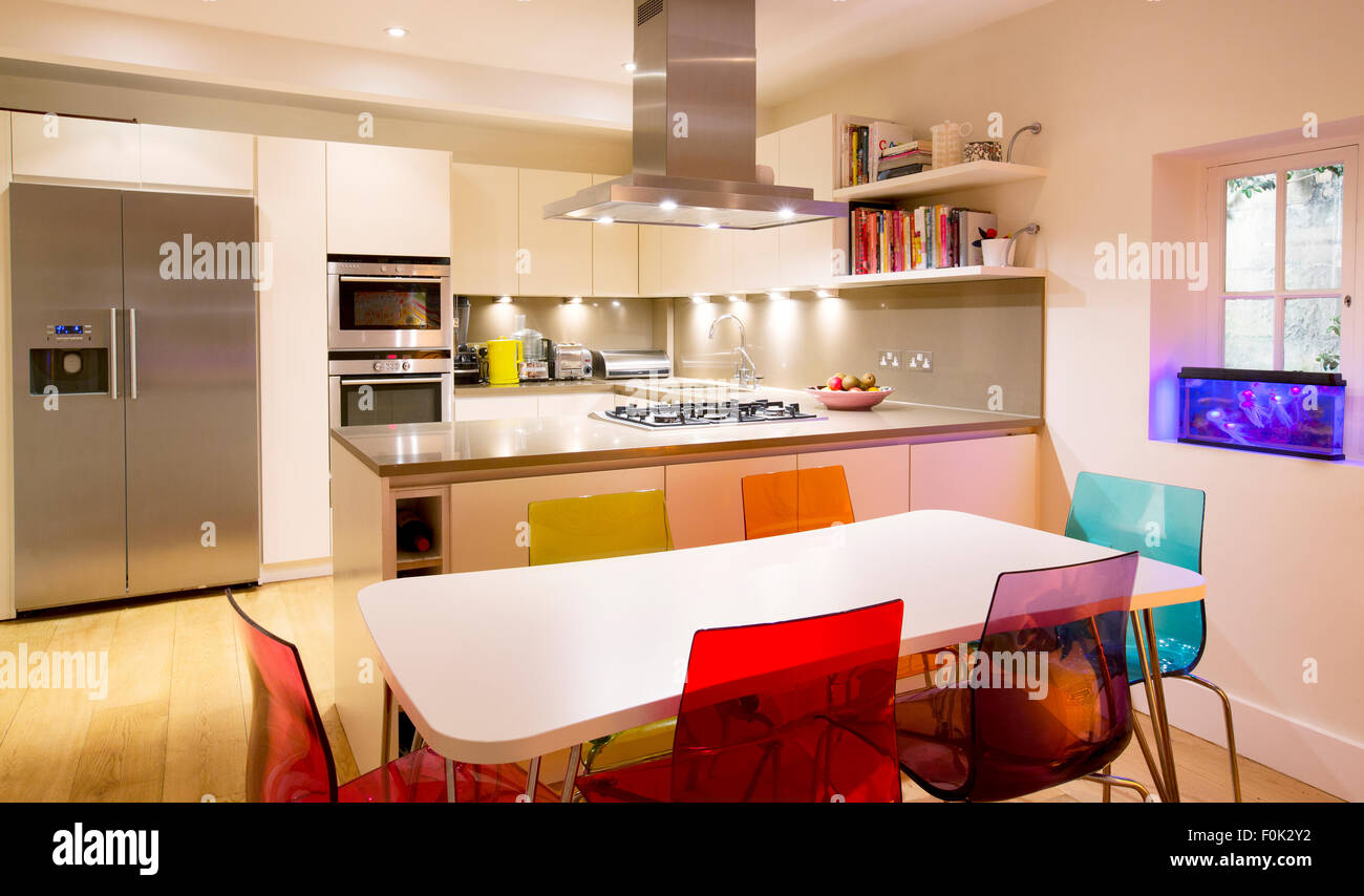 Modern kitchen and dining table Stock Photo - Alamy