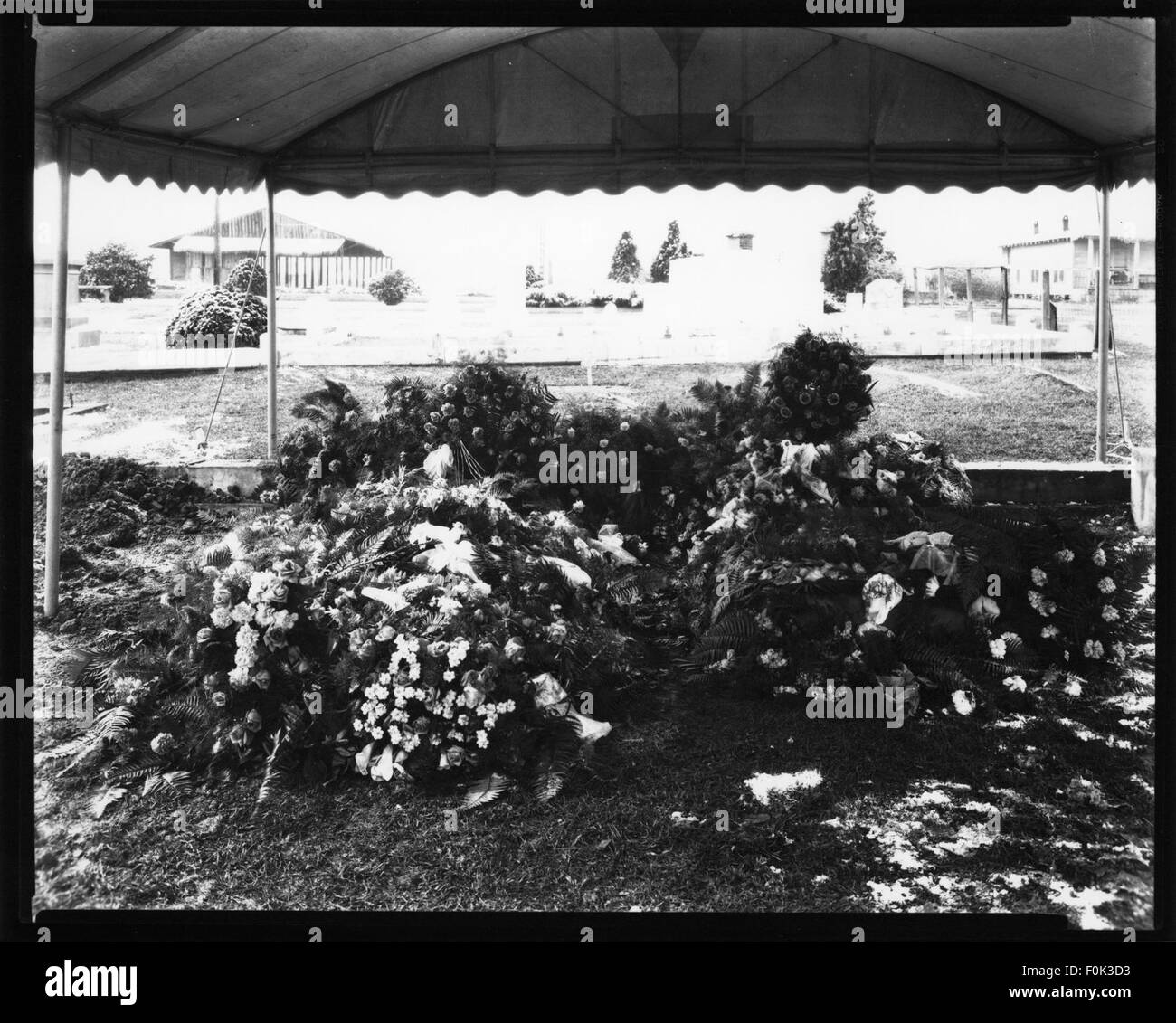 This photograph depicts a funeral gravesite within a cemetery, a place ...