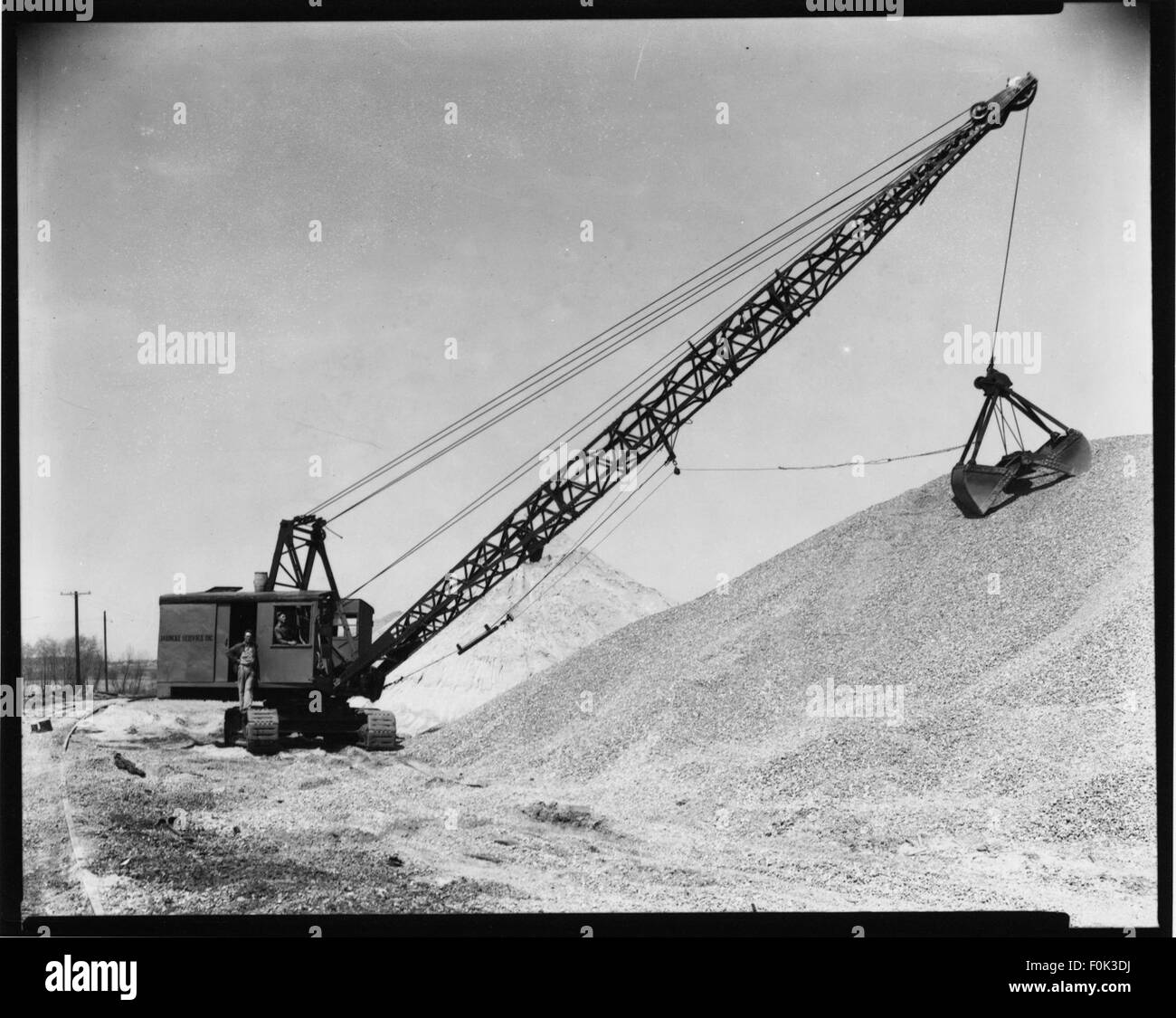 A gravel pit, likely used for construction or road work, showing piles ...