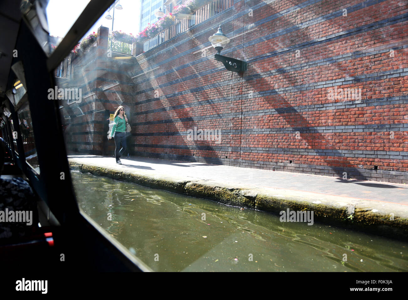 A view from a Birmingham central canal boat shows a female pedestrian ...