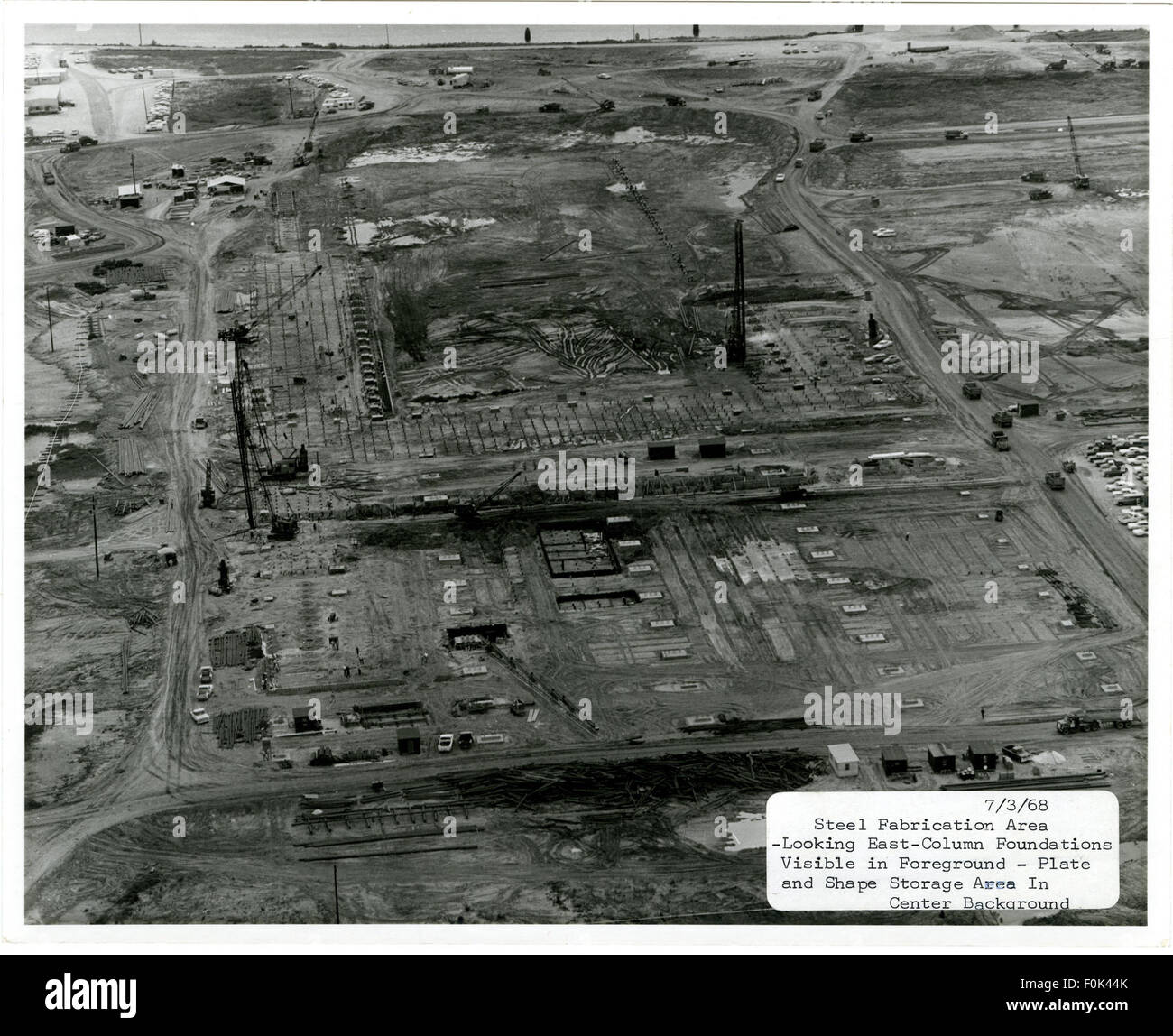 This photograph depicts a steel fabrication area with visible column ...