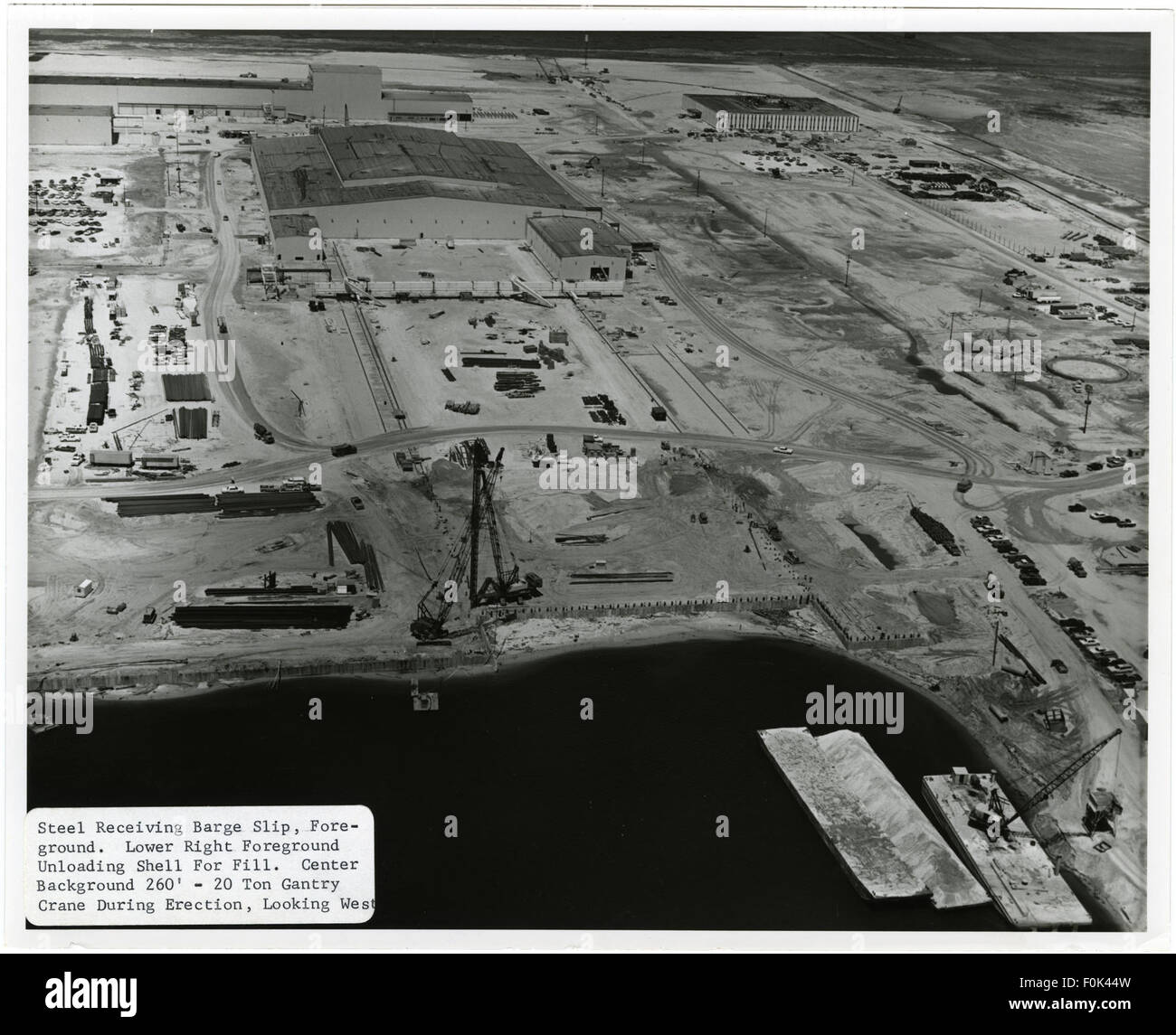 A steel receiving barge slip in the process of unloading materials ...