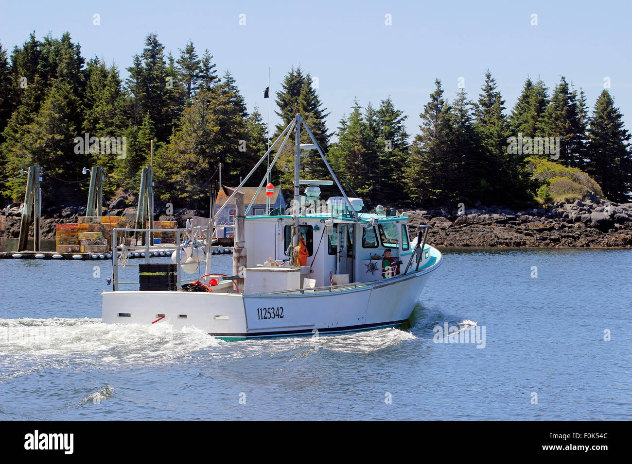 Lobster boats on moorings in harbor waterfront Vinalhaven Island Maine ...