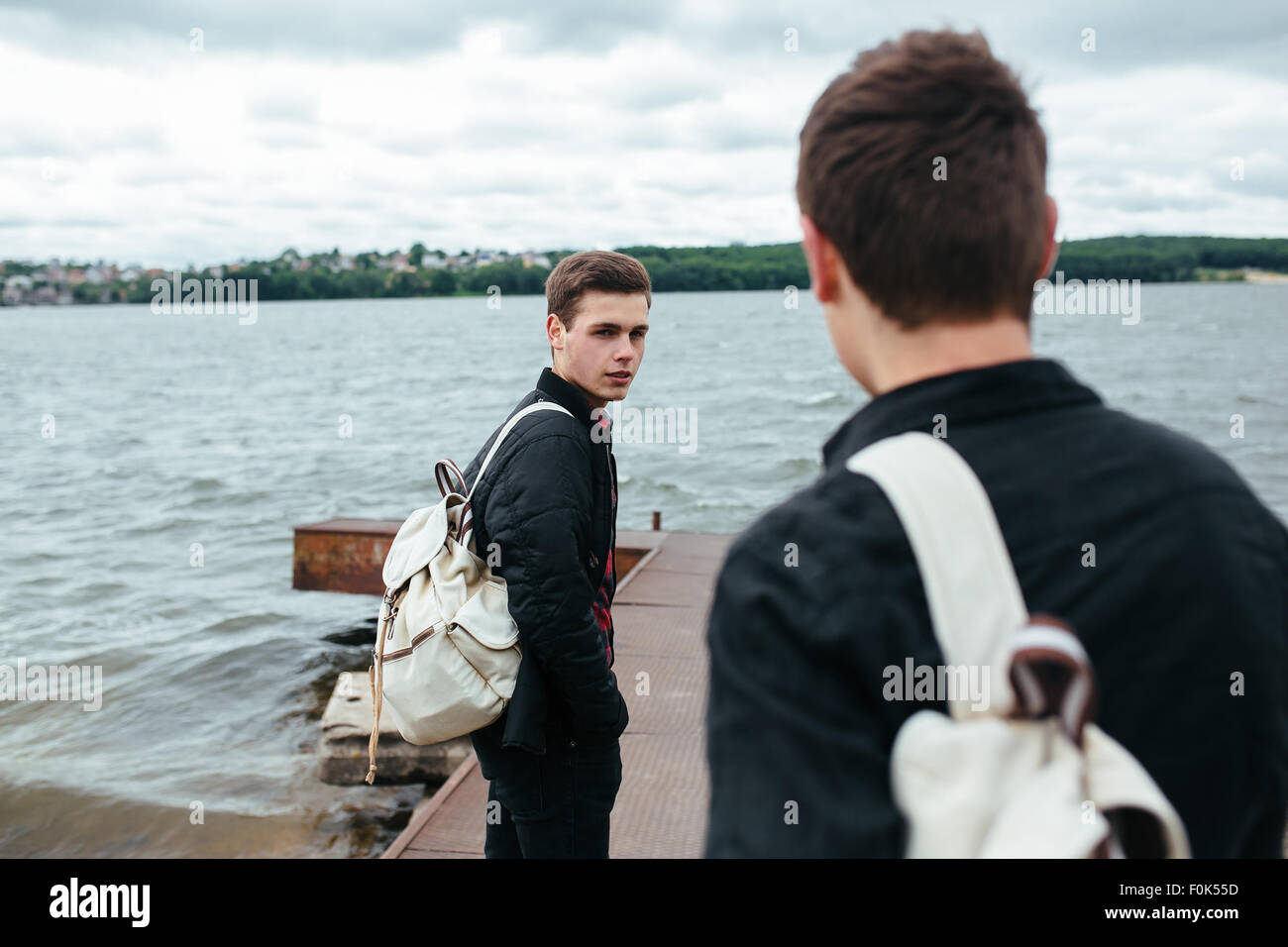 two young guys standing on a pier Stock Photo - Alamy