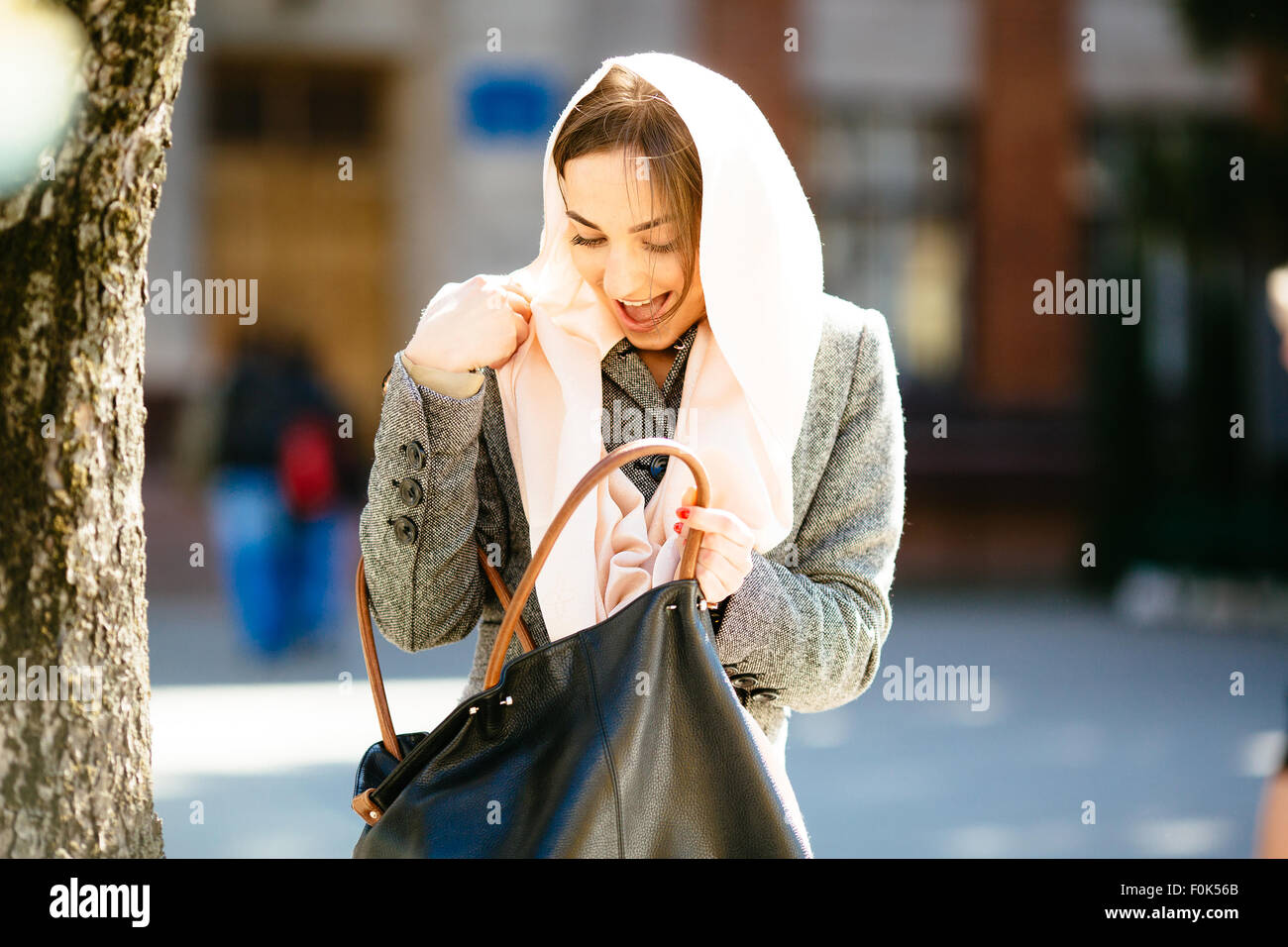 girl looking for something in a bag Stock Photo - Alamy