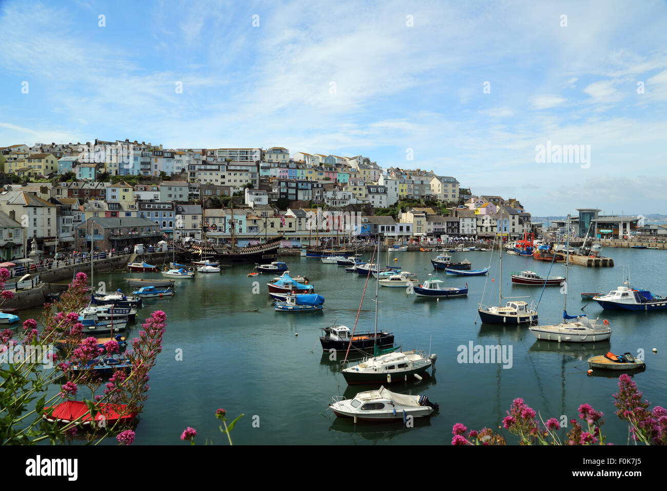 Boats in the inner harbour of Brixham, Devon, England. Houses and ...