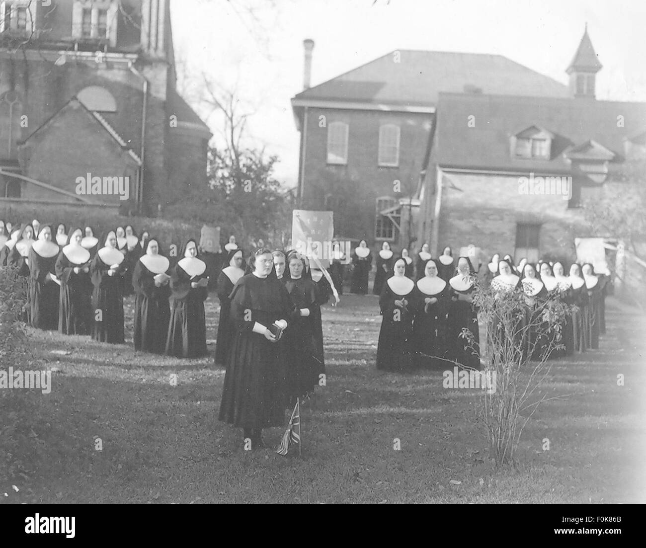 A group of sisters is shown outdoors at Sacred Heart Convent, engaging ...