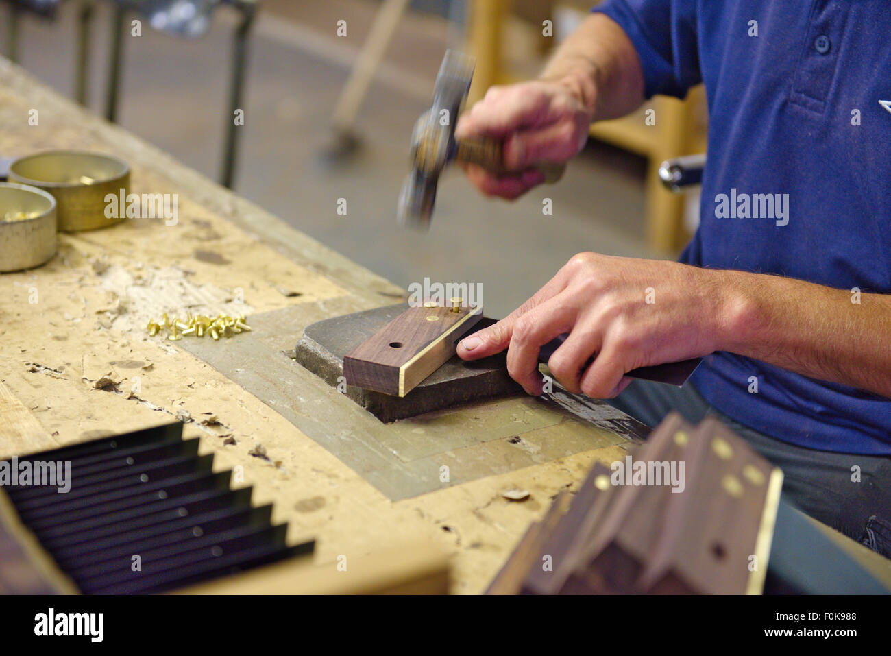 Man assembly woodworking square with hammer and rivets, Sheffield, UK ...