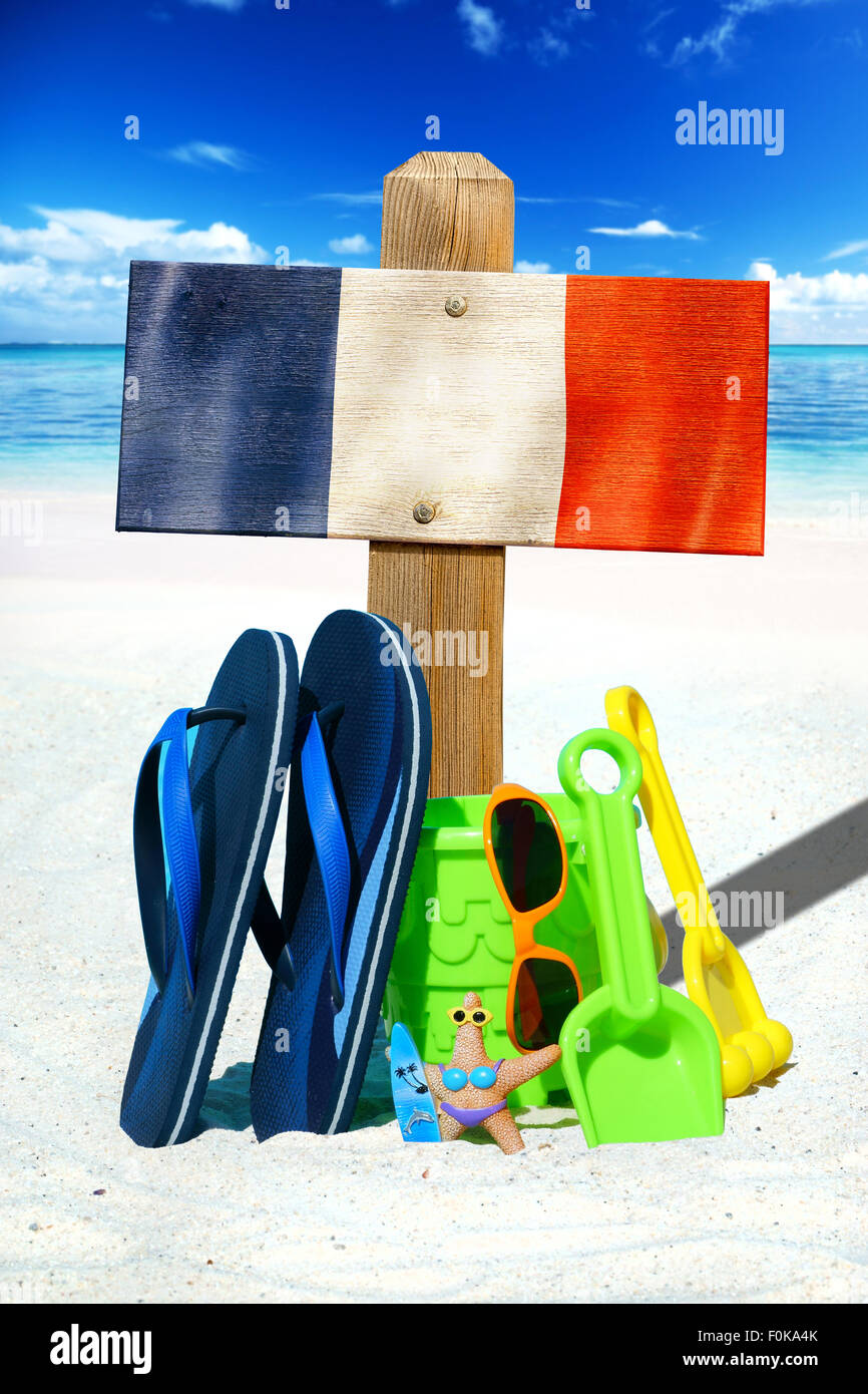Wooden signboard with the France flag, blue flip flops and colorful ...