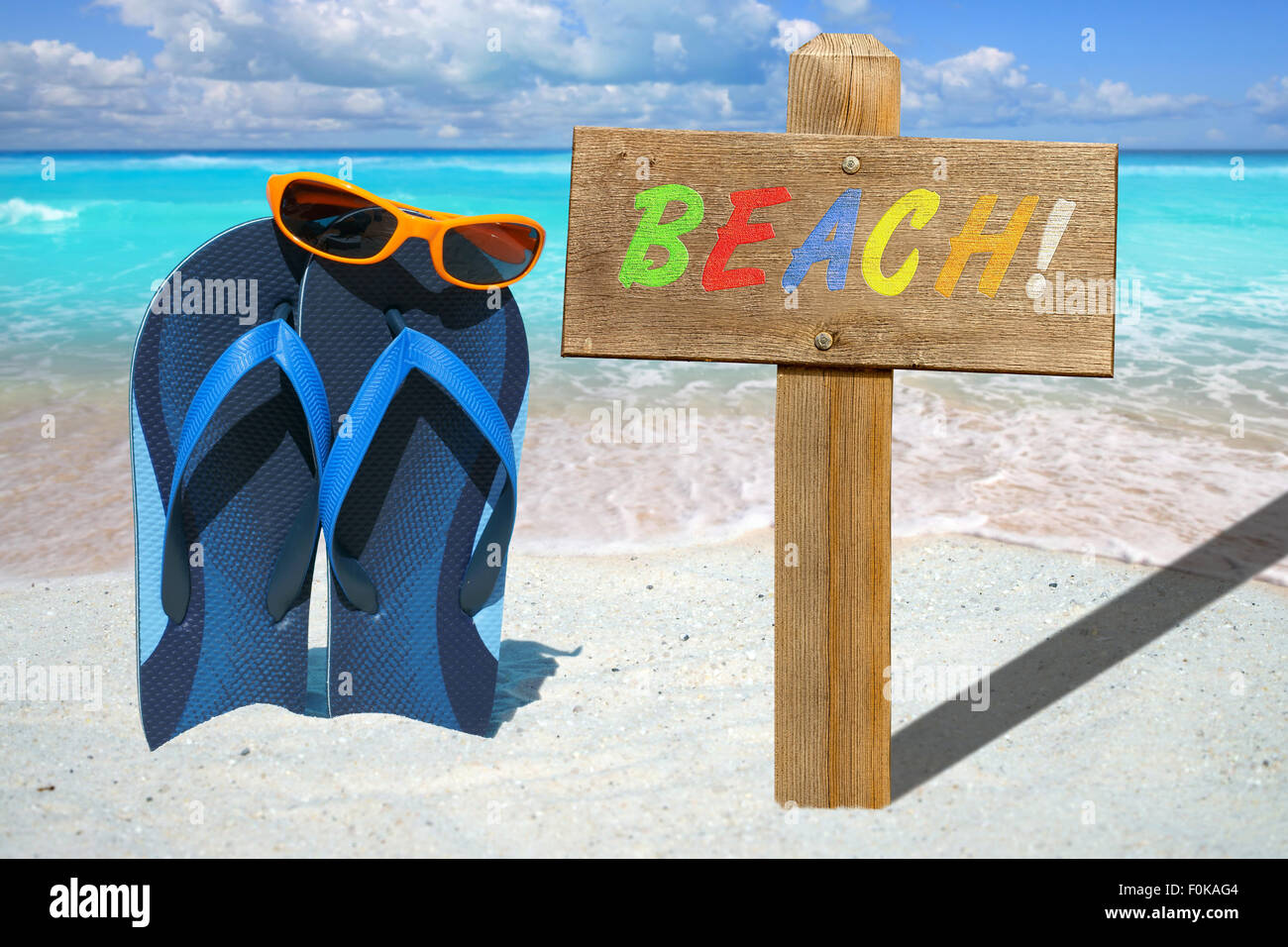 Blue flip flops, sunglasses and wooden signboard with text message on ...