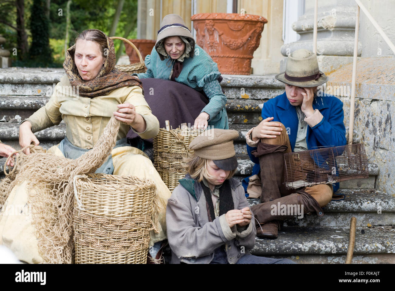 Lower Class Family Sitting On The Steps Of A House In The