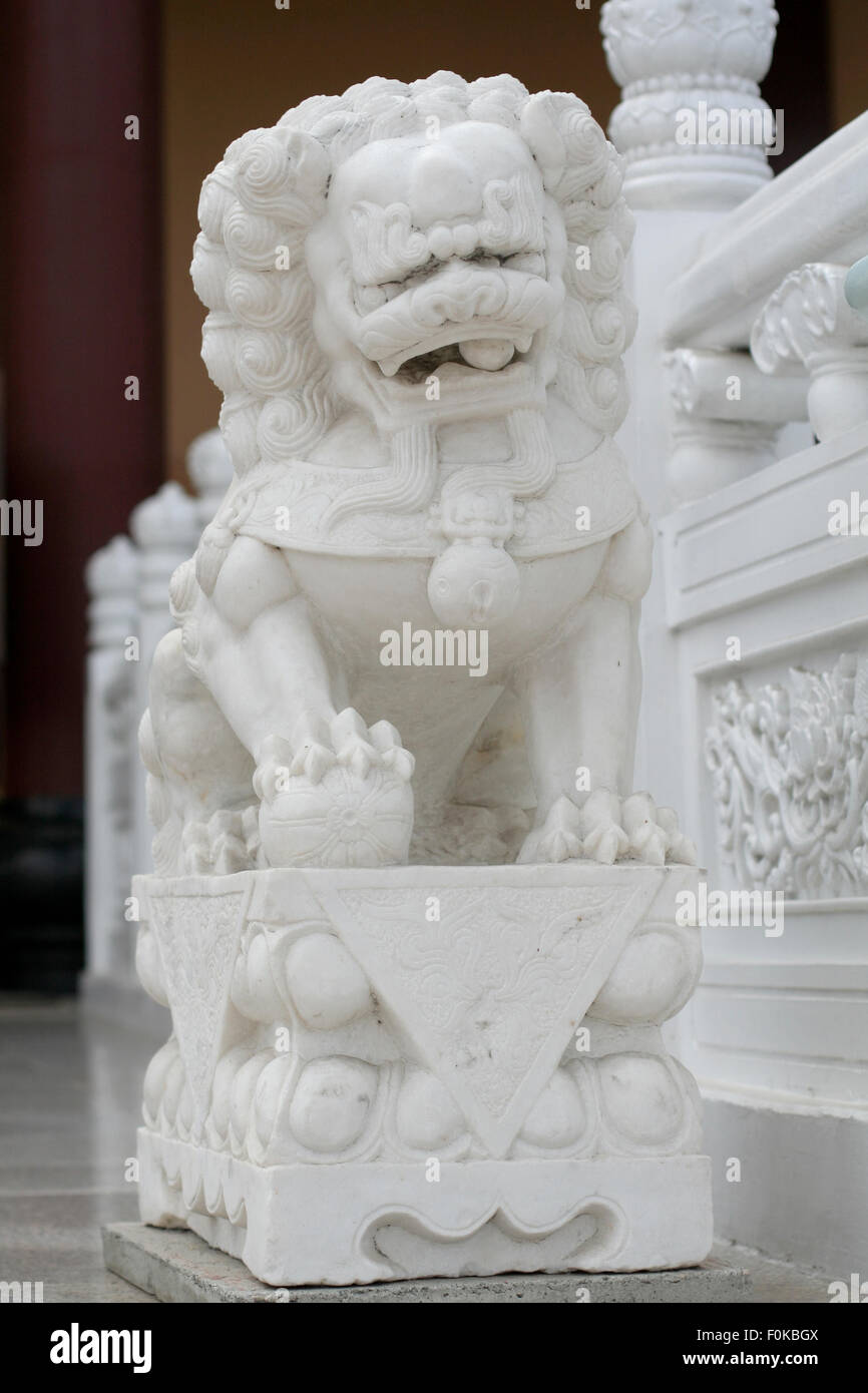 Temple guardian lion white stone sculpture front Stock Photo - Alamy