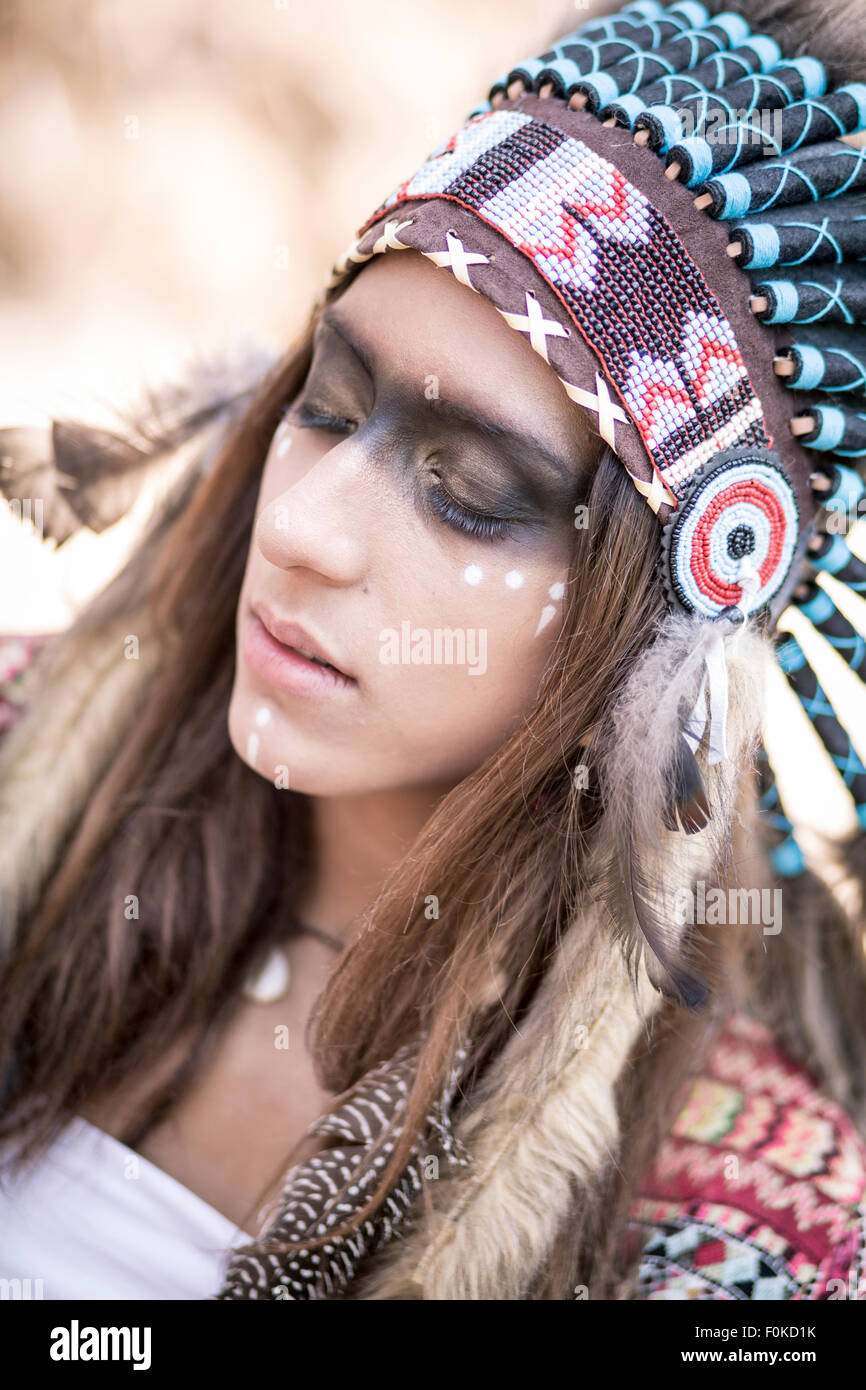 Portrait of young woman masquerade as an Indian Stock Photo - Alamy