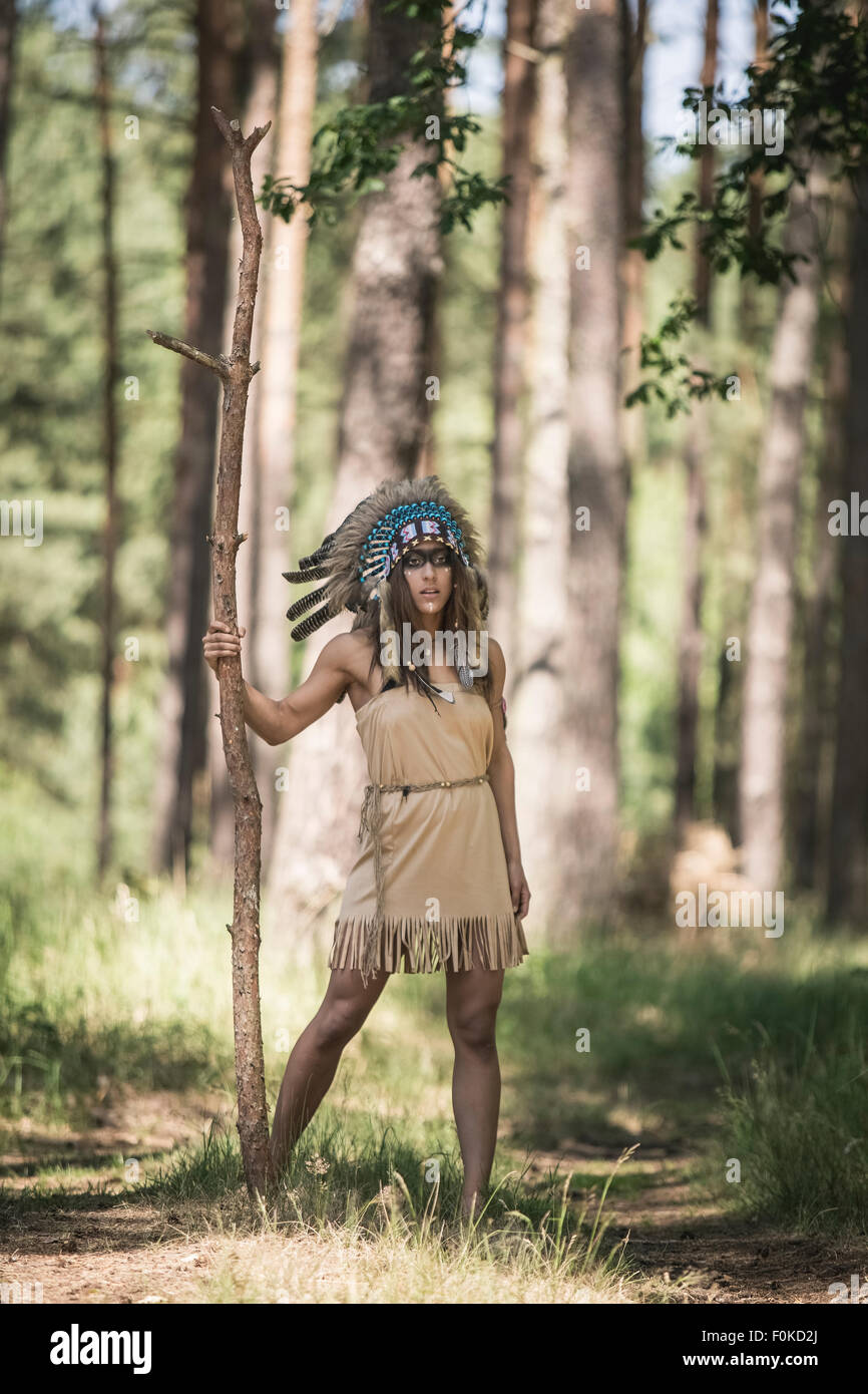 Young woman masquerade as an Indian standing in the woods Stock Photo ...