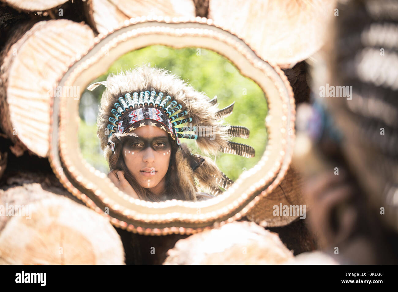 Mirror image of young woman masquerade as an Indian Stock Photo - Alamy