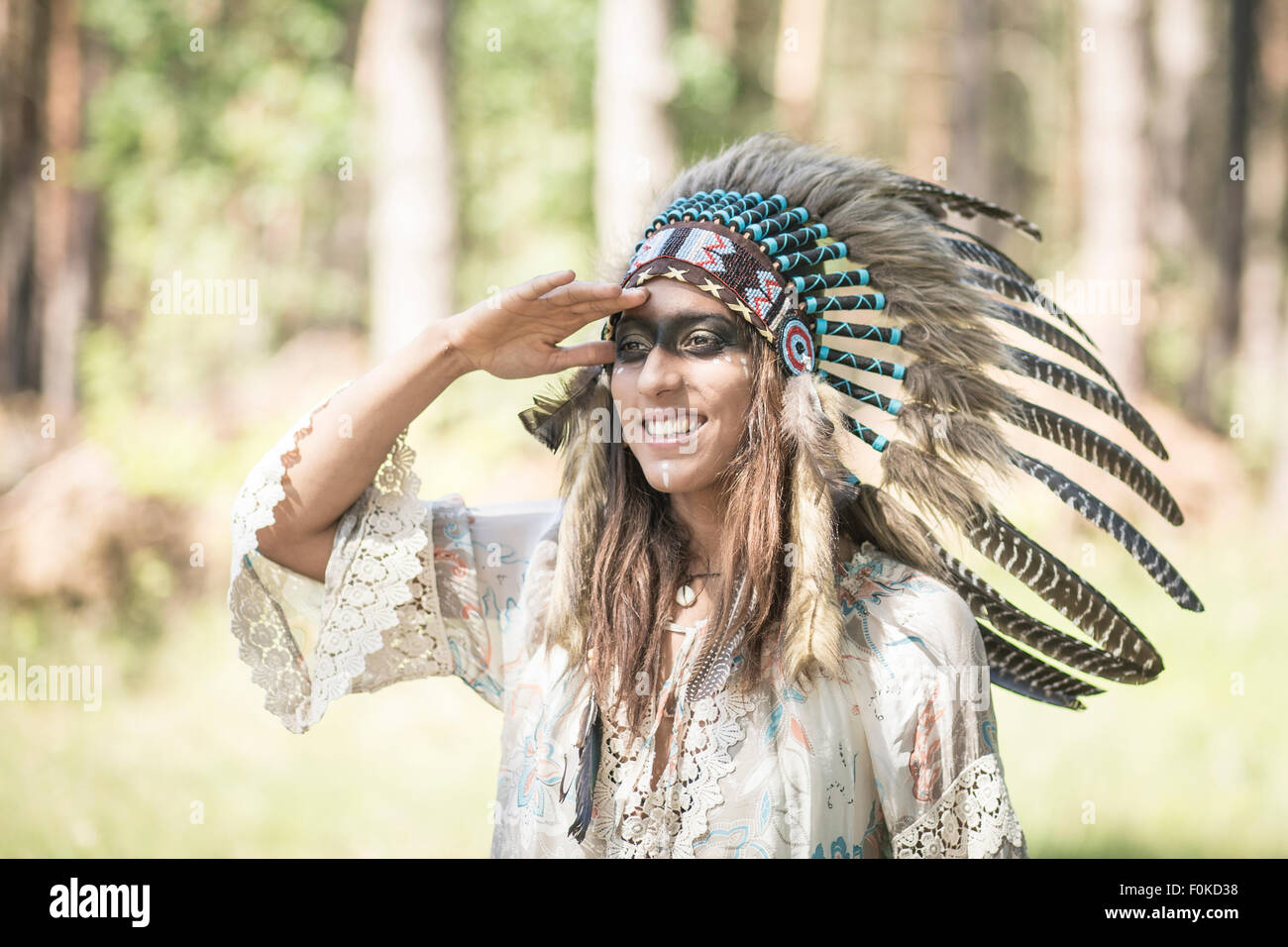 Portrait of smiling young woman masquerade as an Indian Stock Photo - Alamy