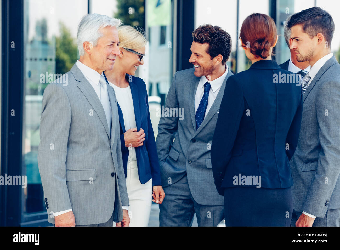 Group of confident business people talking Stock Photo - Alamy