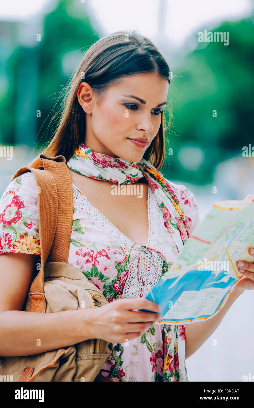 Young woman reading map Stock Photo - Alamy