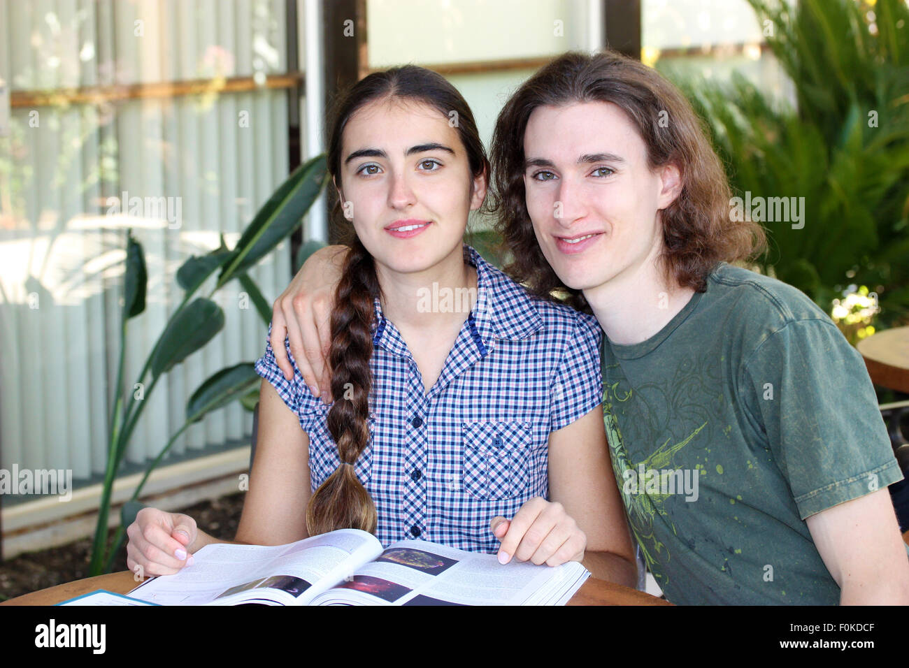 Young students reading book on college campus Stock Photo - Alamy