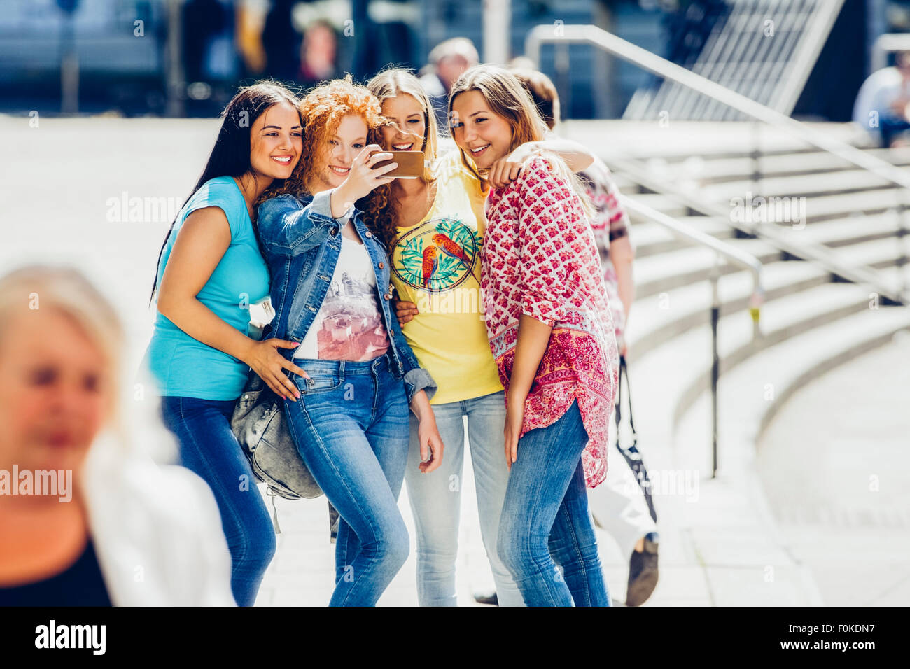 Group of four female friends taking a selfie with smartphone Stock ...